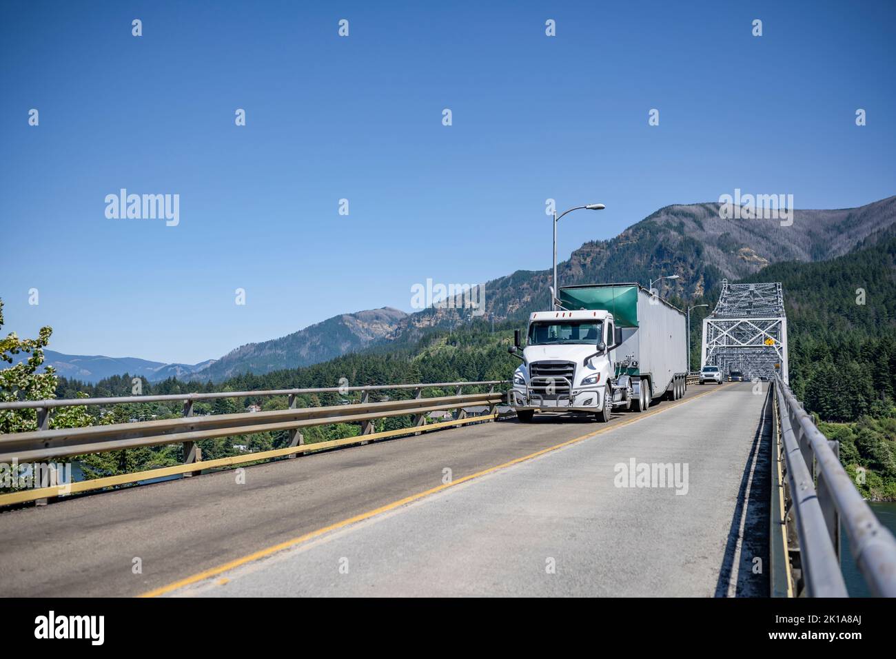 Industrial classic local day cab big rig white semi truck transporting ...