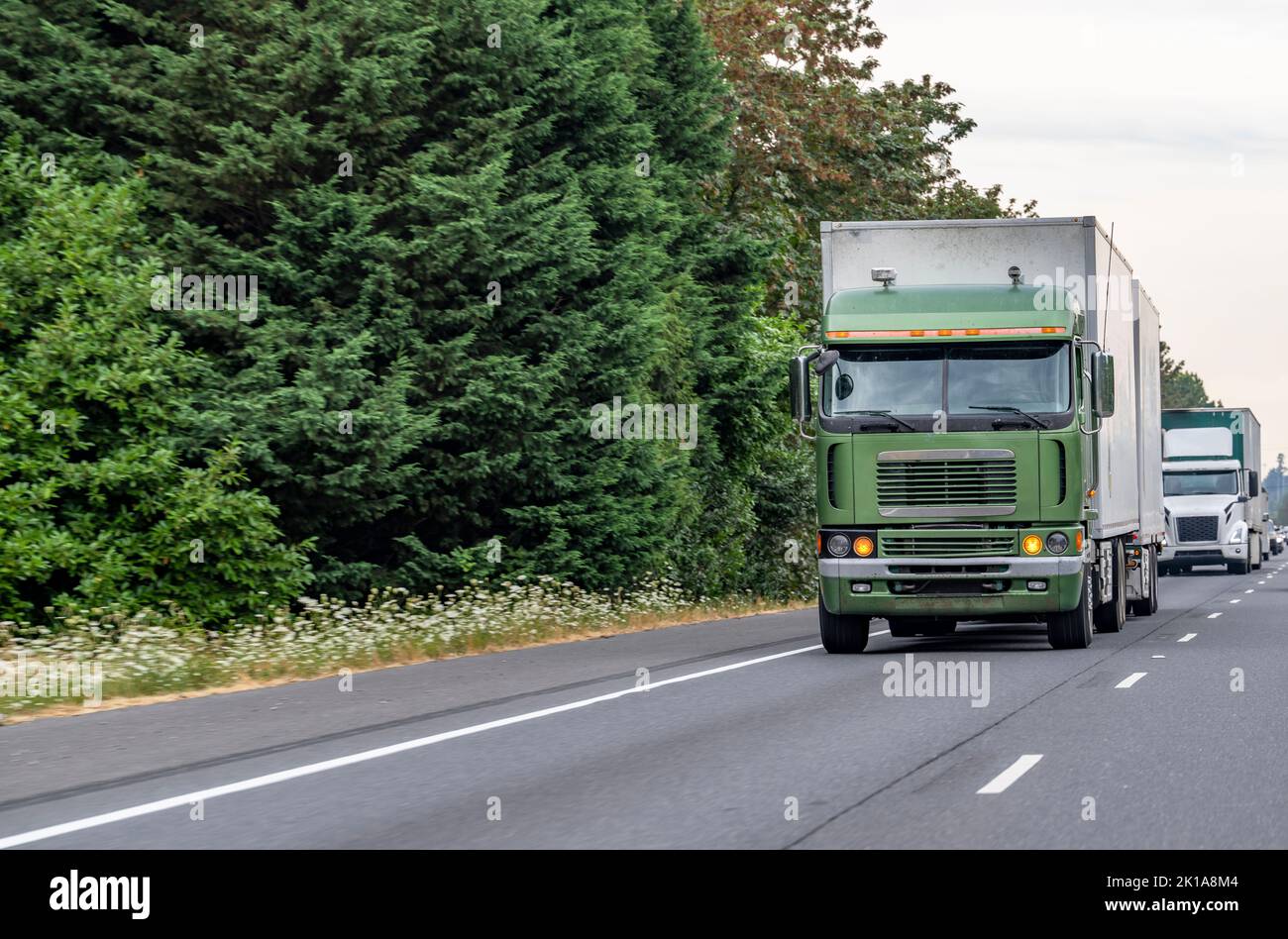 Classic old style cab over green big rig semi truck tractor ...