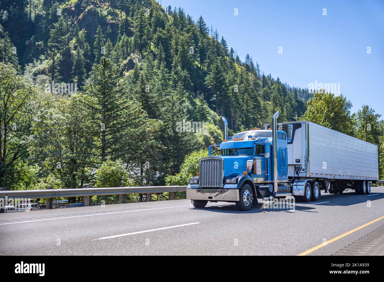 Classic blue long haul big rig semi truck tractor with chrome exhaust ...
