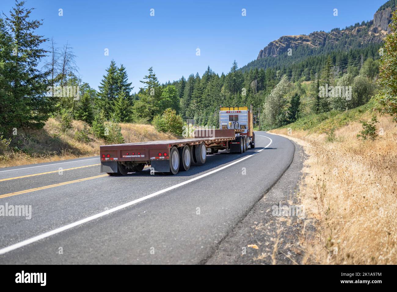 Bonnet powerful yellow big rig semi truck with empty flat bed semi ...