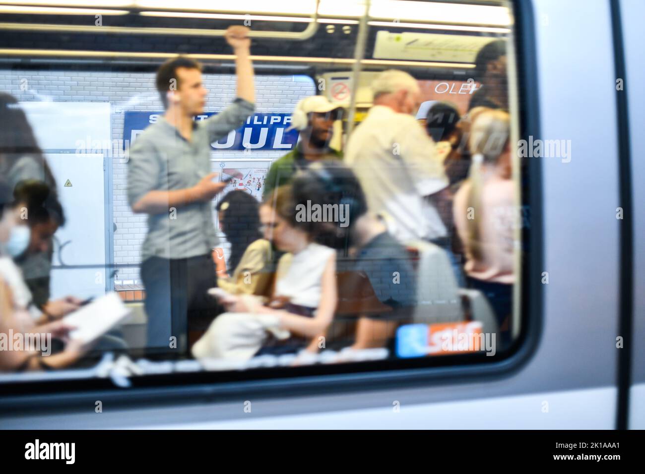 People inside the metro, in a parisian subway (metropolitain) station ...