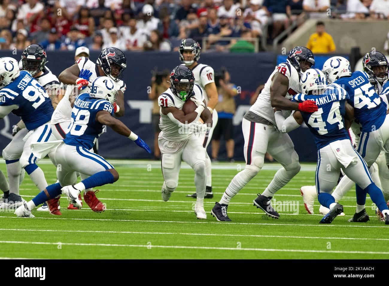 Houston Texans running back Dameon Pierce (31) runs through the hole ...