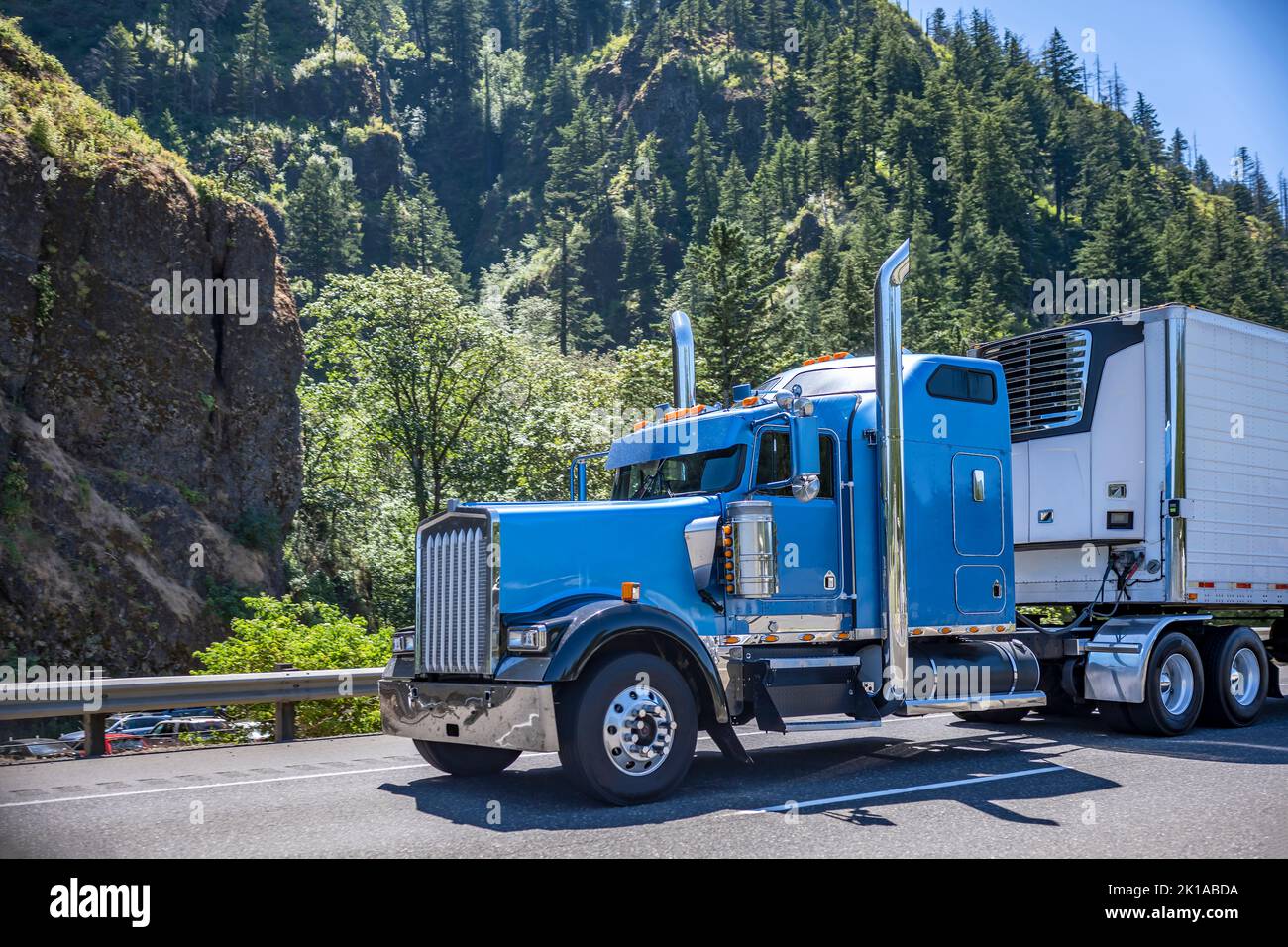 Classic blue long haul big rig semi truck tractor with chrome exhaust ...