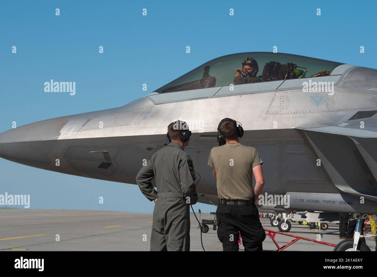U.S. Air Force F-22 Raptor pilot, Capt. “Swiss” Ritschard, left, and ...
