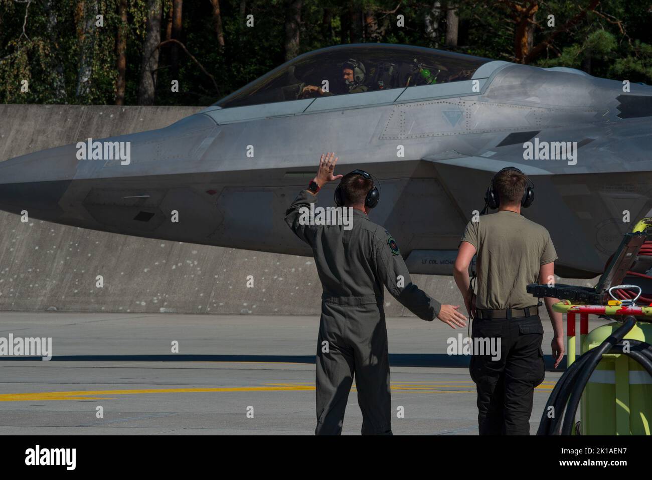 U.S. Air Force F-22 Raptor pilot, Capt. “Swiss” Ritschard, left, and ...