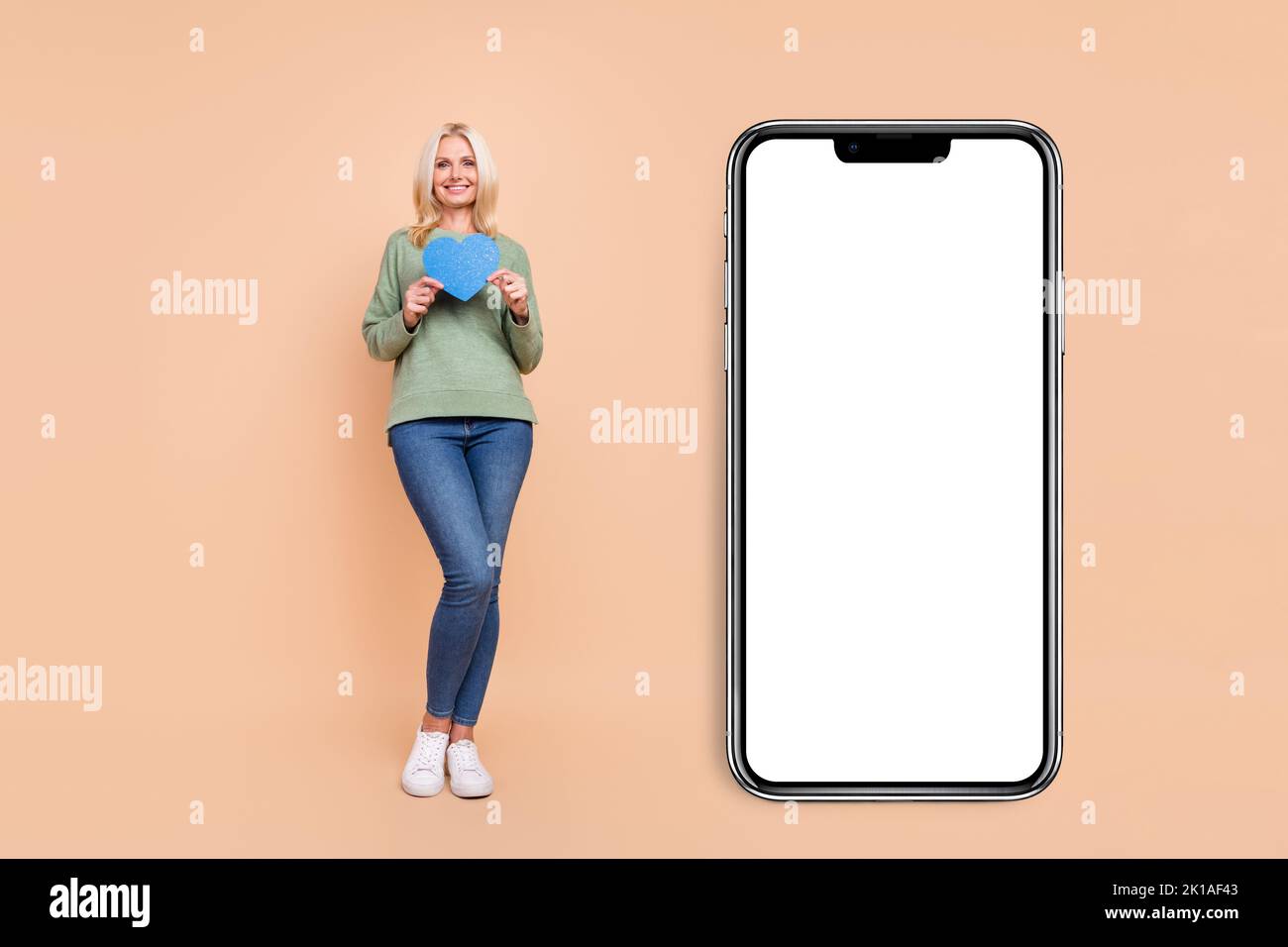 Photo of adorable cute retired woman wear green sweater holding blue ...