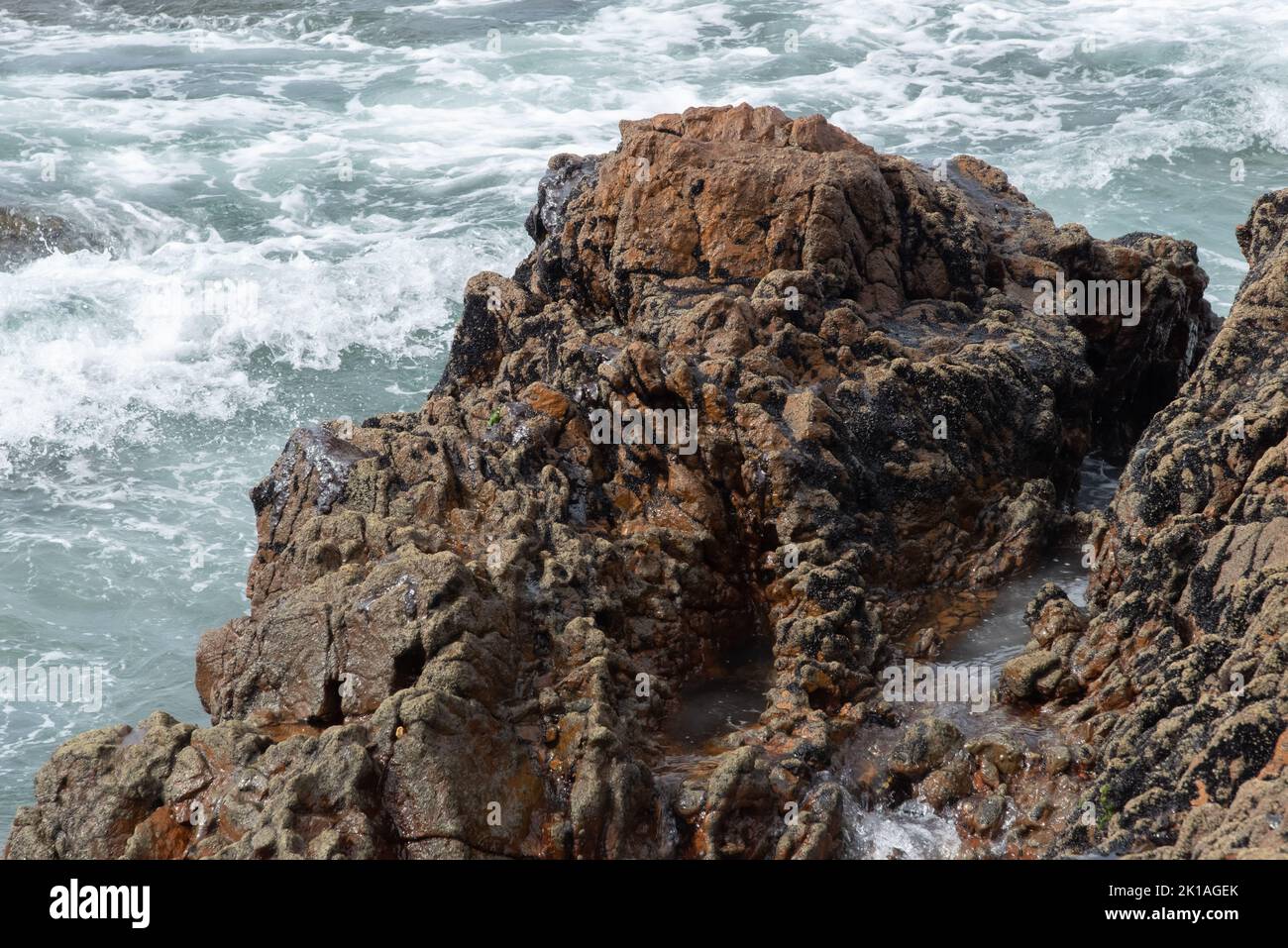 The sea beach and the rocks are polluted with oil. Crude oil spill in ...