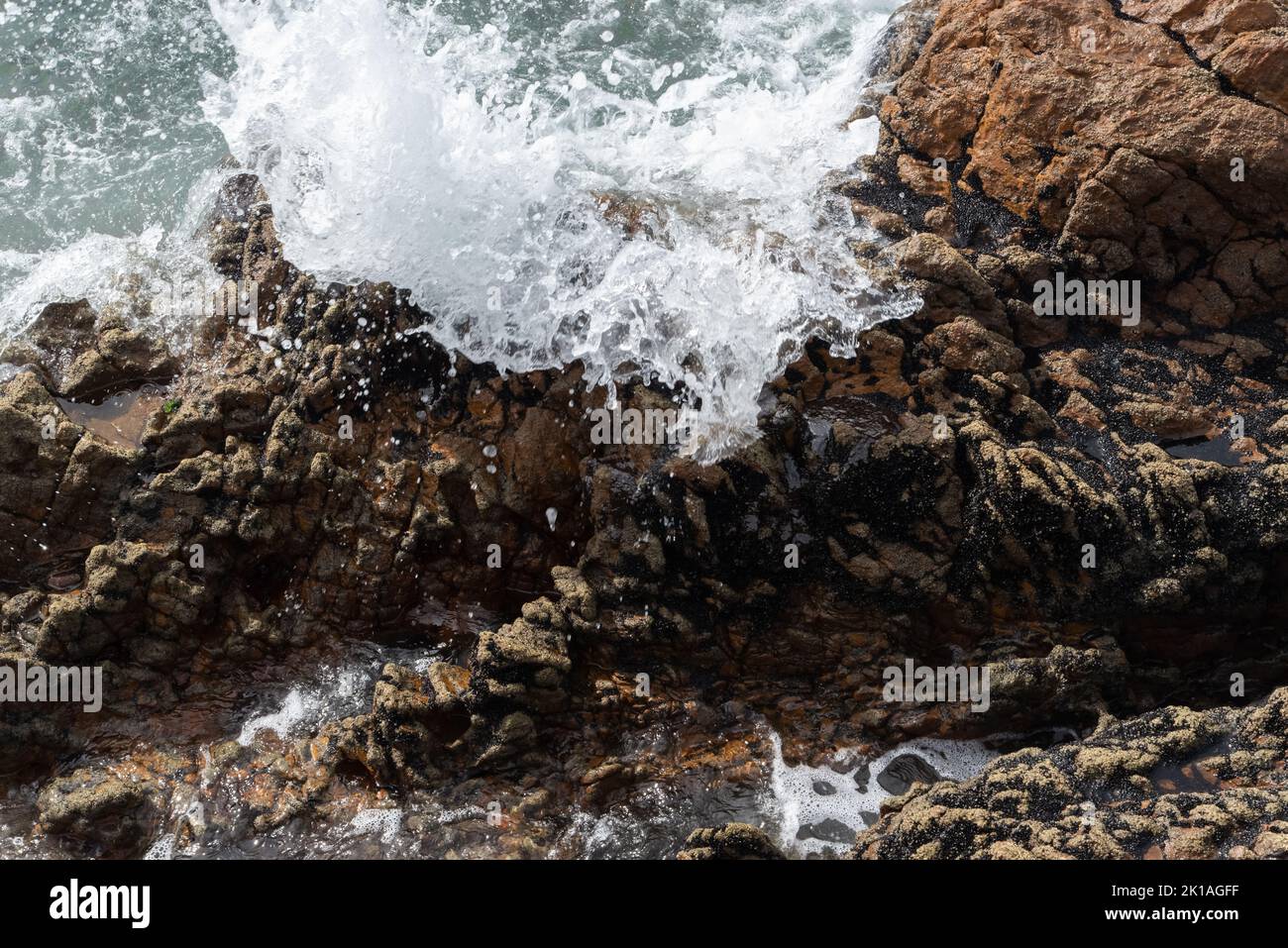 The sea beach and the rocks are polluted with oil. Crude oil spill in ...