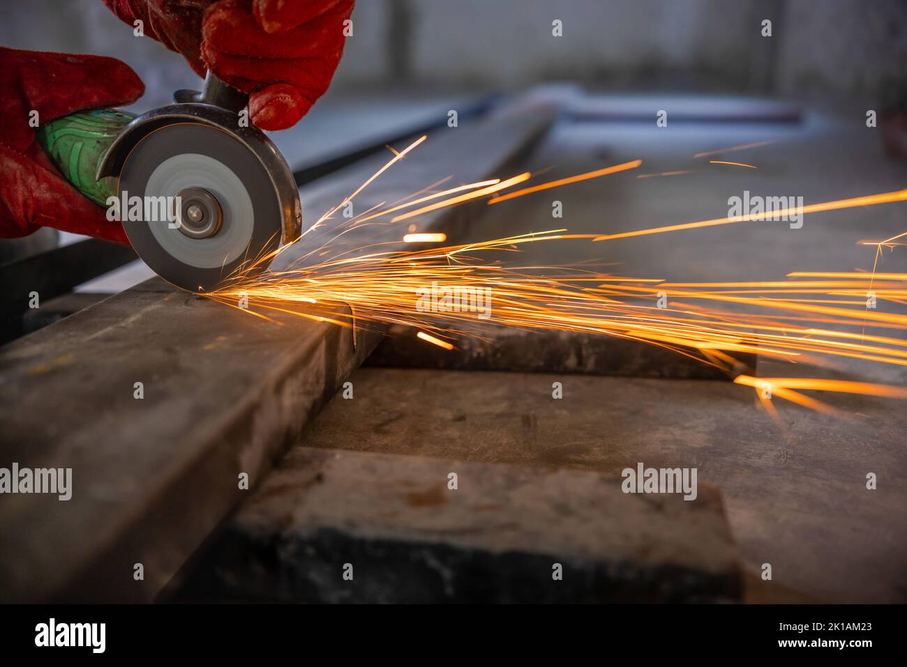 Worker cutting steel rectangular pipe in construction site Stock Photo ...
