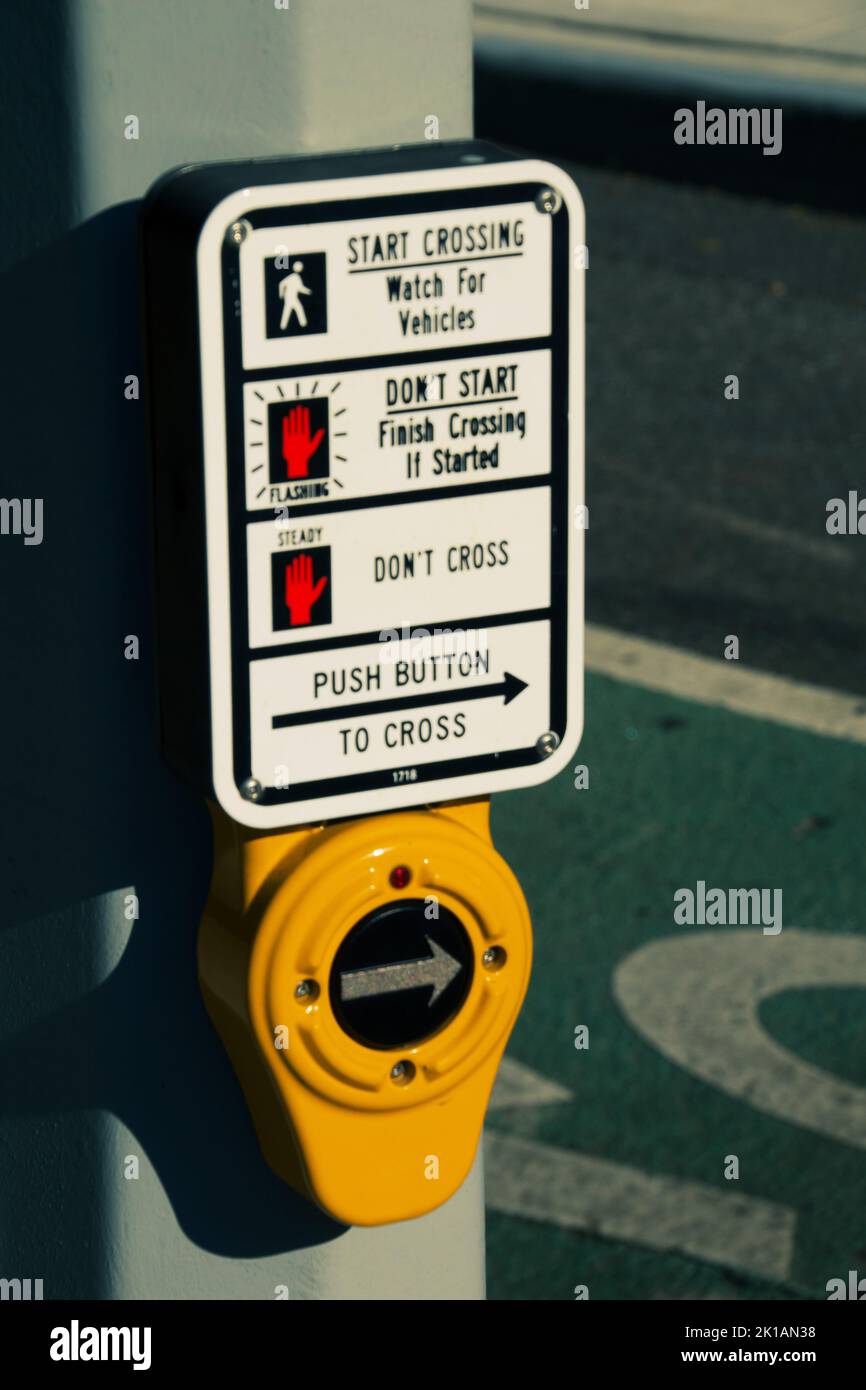 A vertical of the pedestrian crossing button with signs on it Stock ...