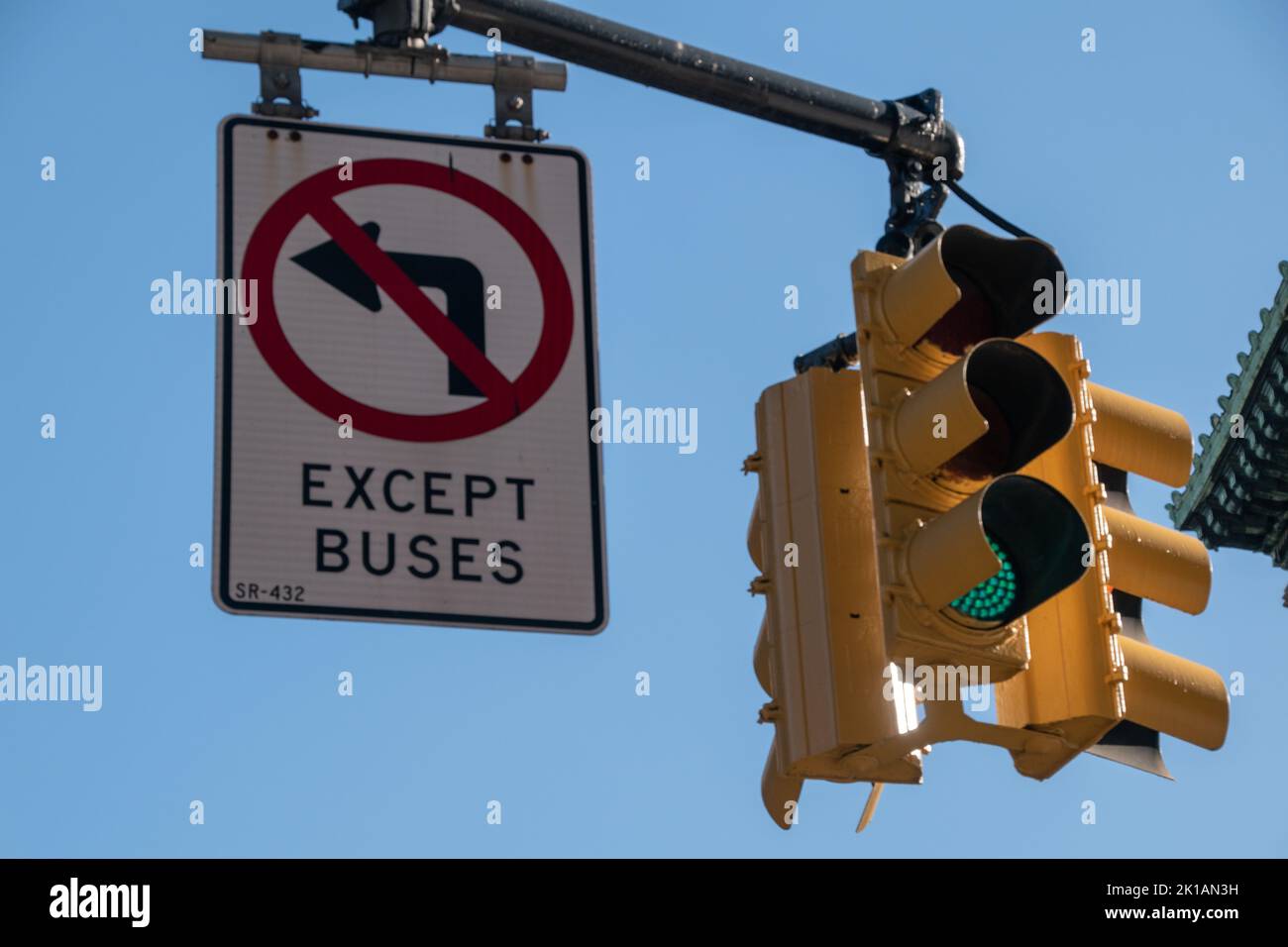 The except buses sign and a yellow traffic light Stock Photo - Alamy