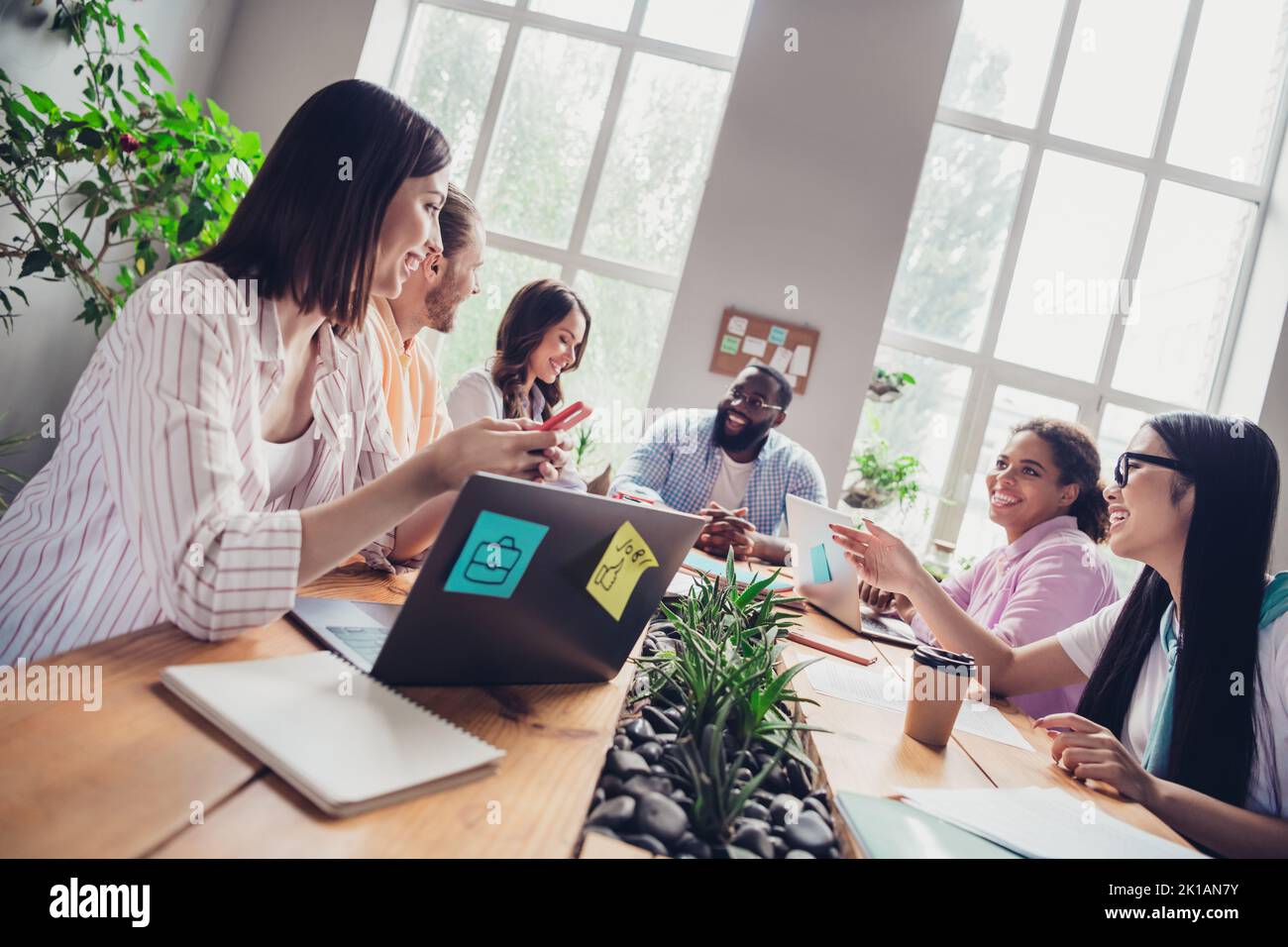 Photo of good mood businesspeople working typing modern devices indoors ...