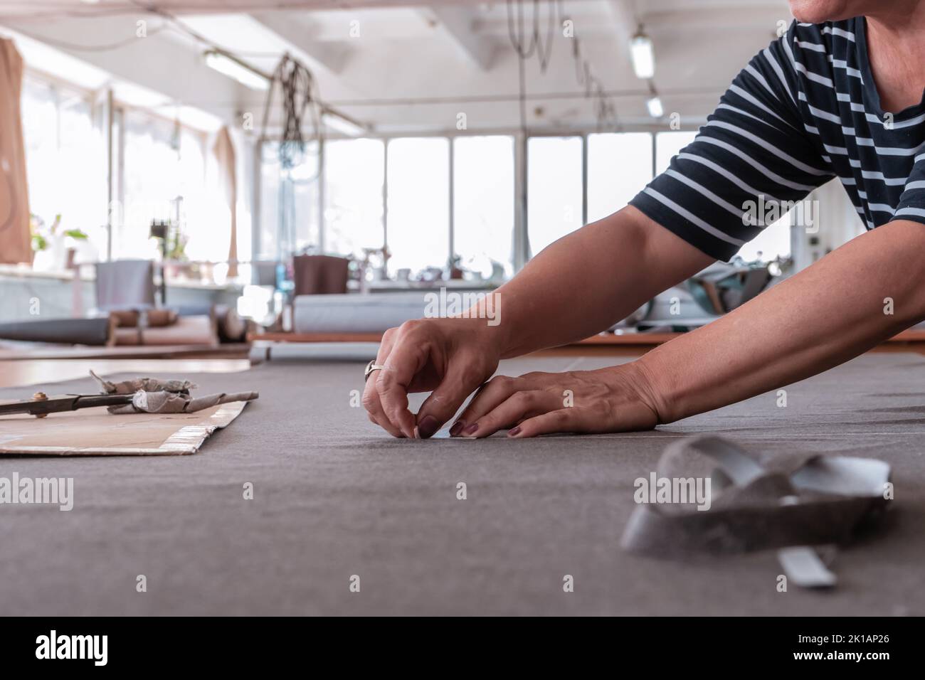 The cutter marks the fabric for cutting in the sewing workshop Stock ...