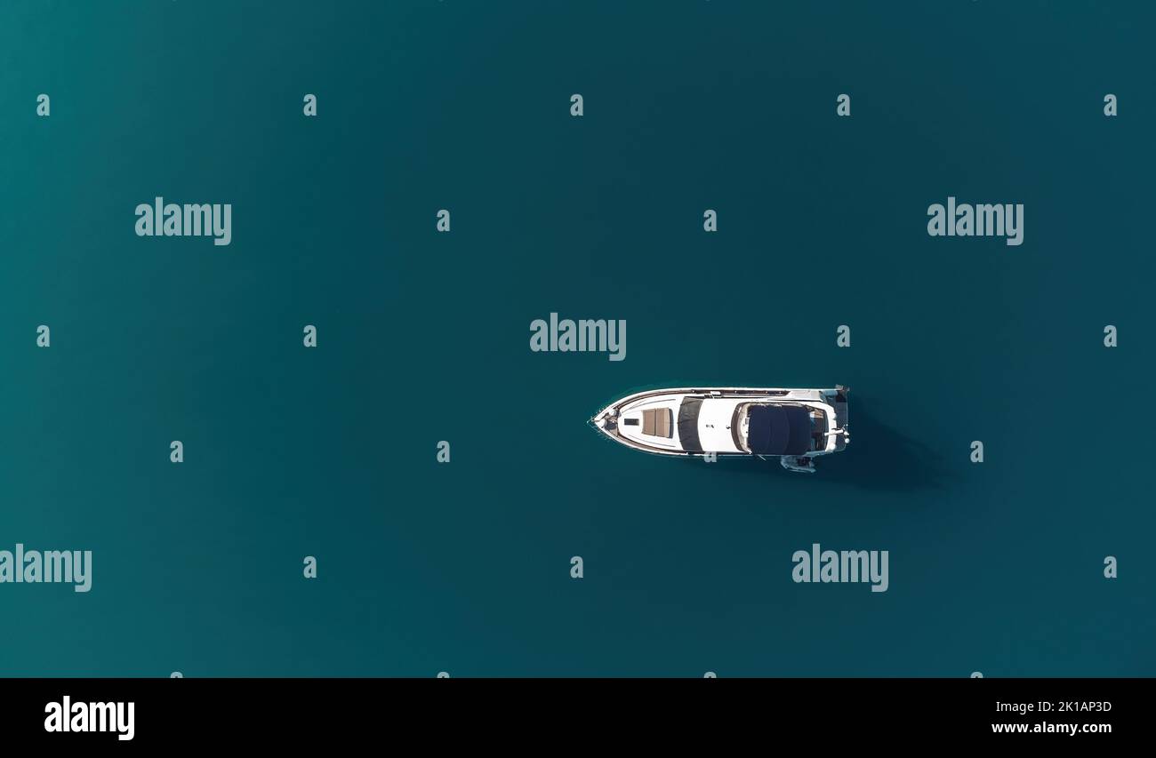 Aerial yacht on calm sea. Luxury cruise trip. View from above of white ...