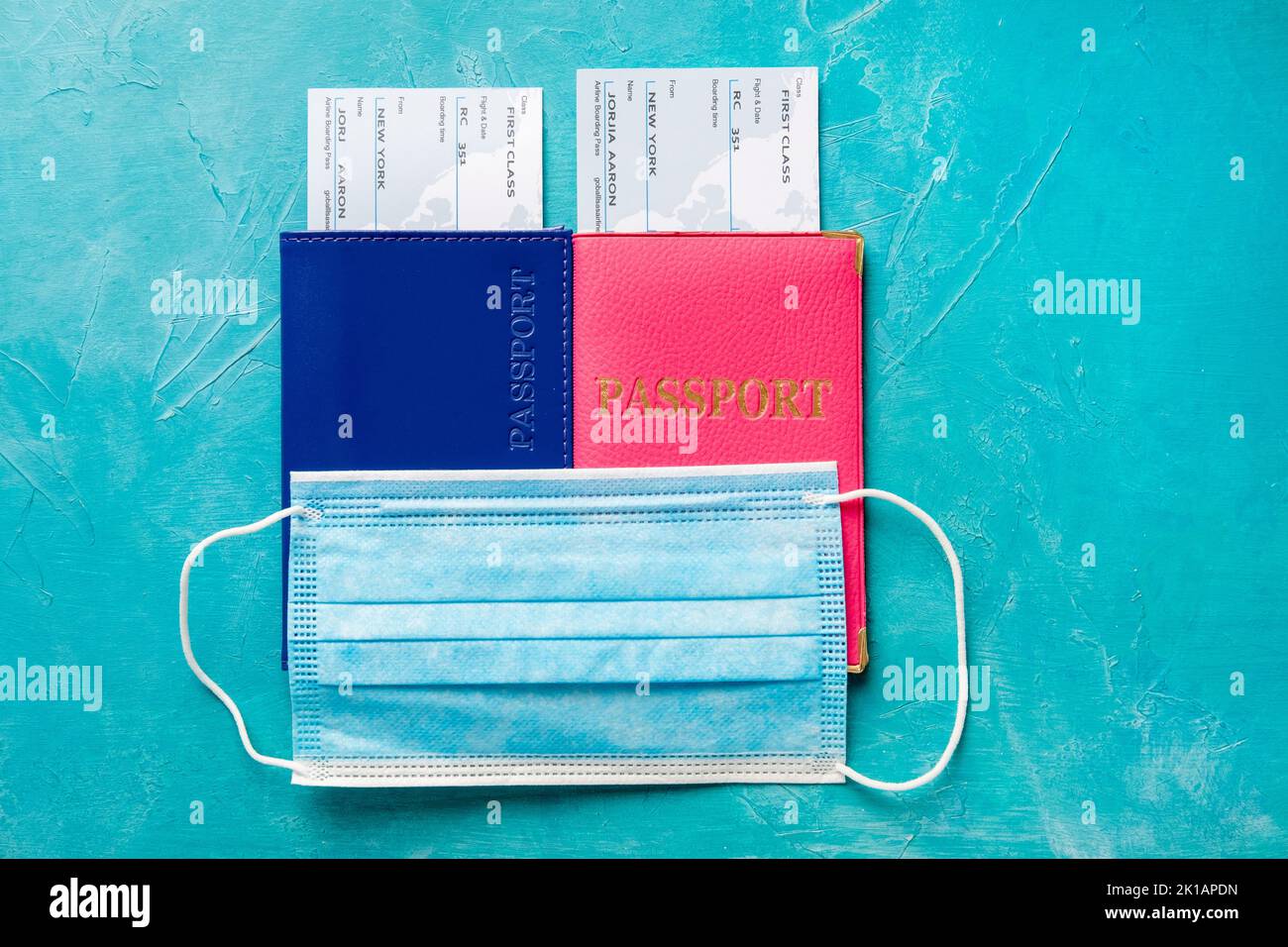 Family trip. Hygiene protection. Pink and blue passports with tickets ...