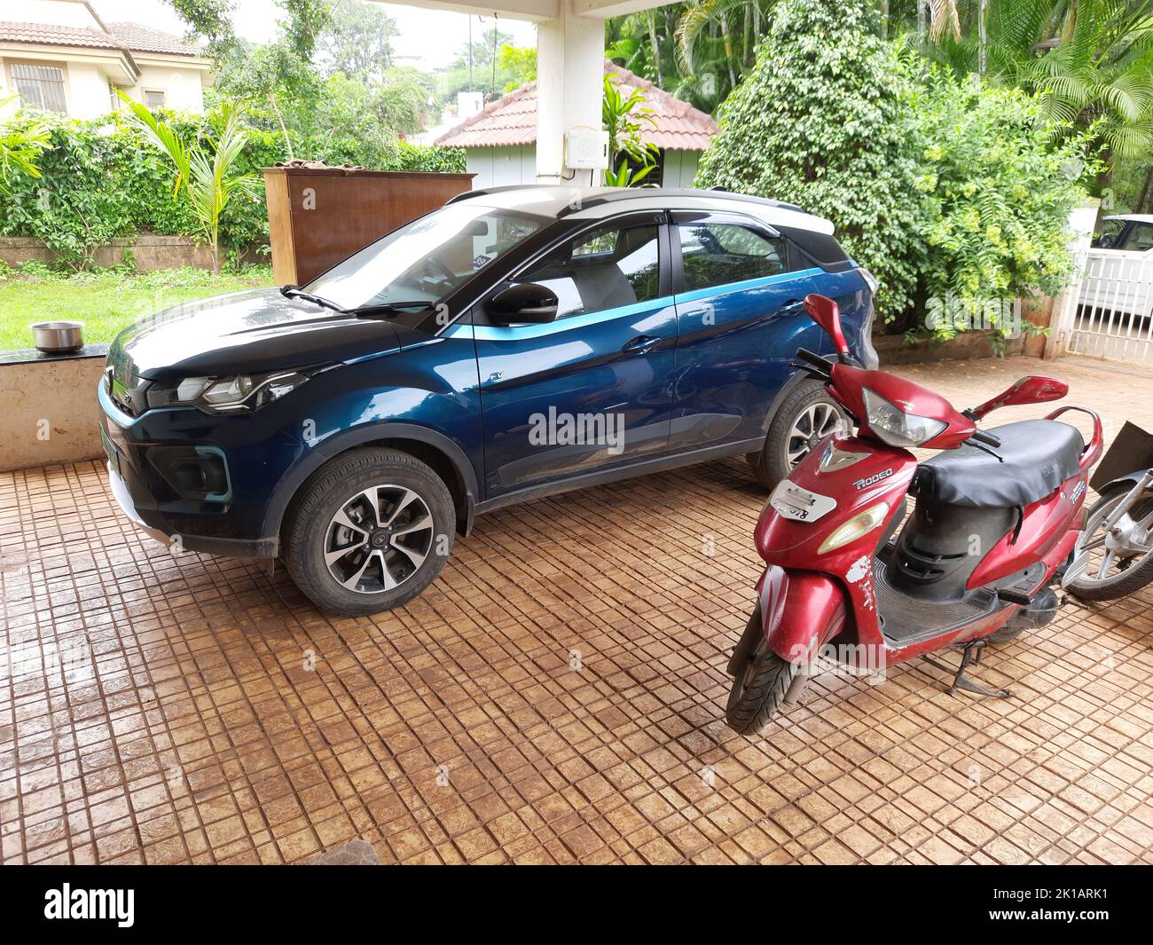 Car and Scooter parked in house garage attached to a residential ...