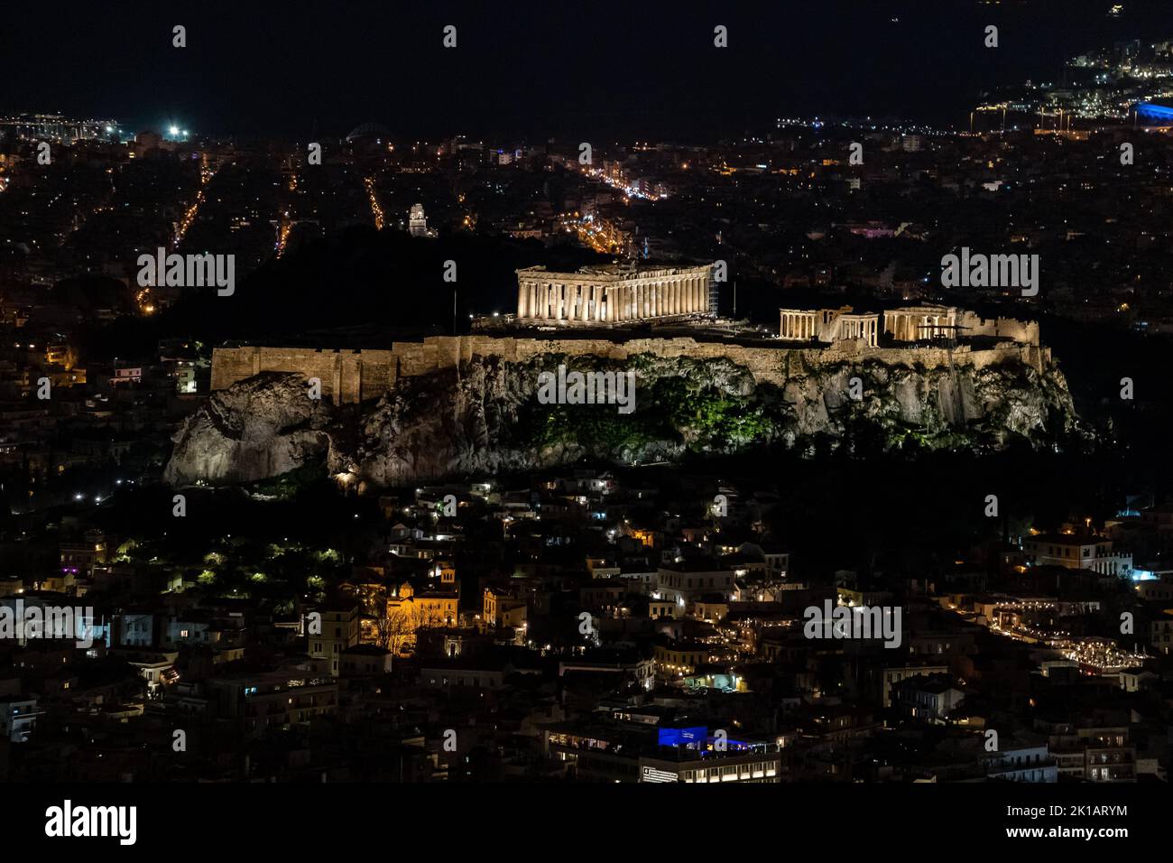 An aerial view of cityscape Athens surrounded by buildings in night ...