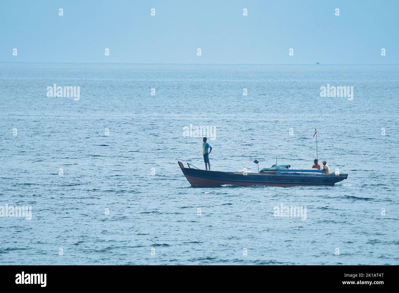 An aerial view of human standing on boat in sea Stock Photo - Alamy