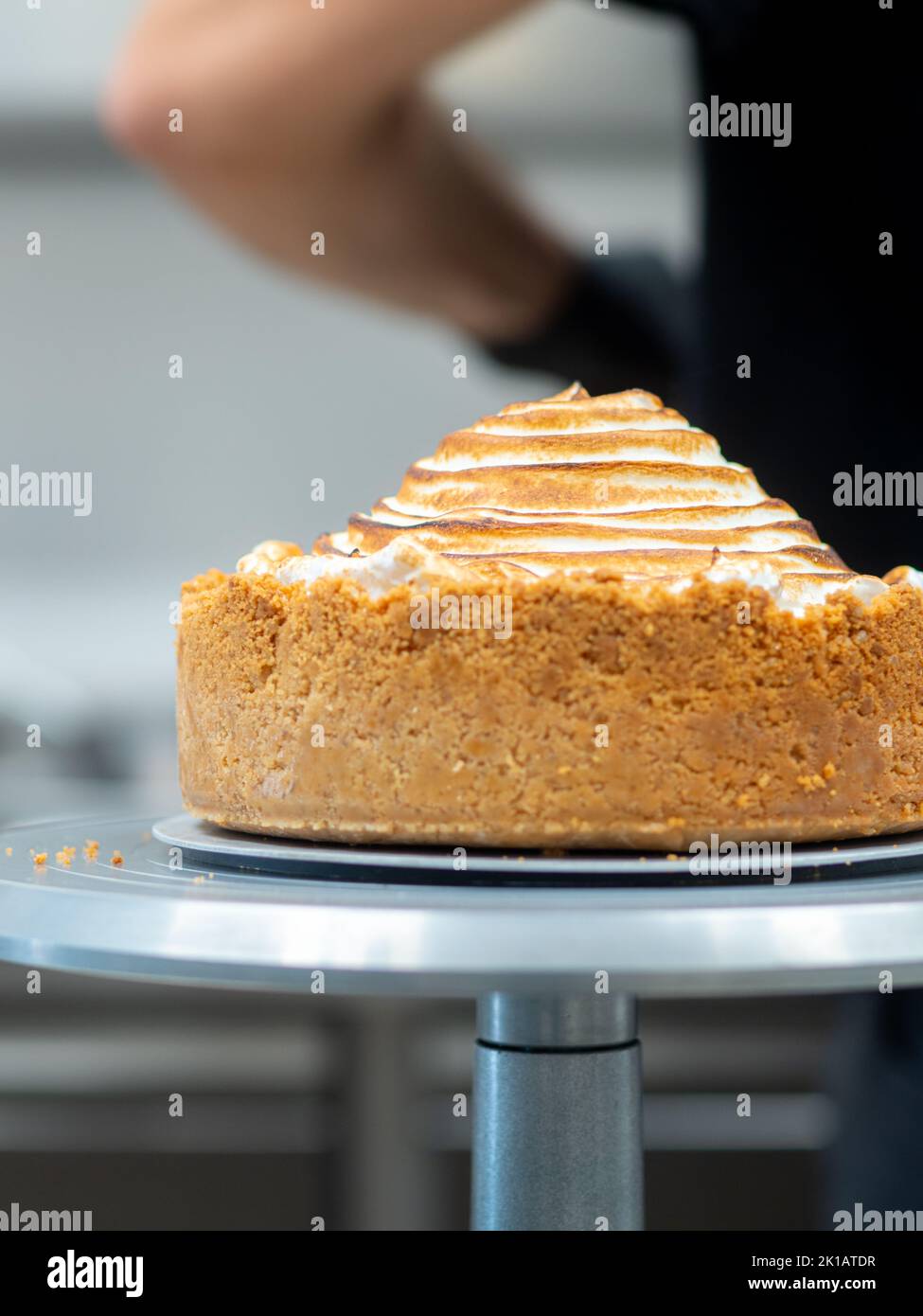 baker using a pastry burner flame torch on a meringue cake Stock Photo ...