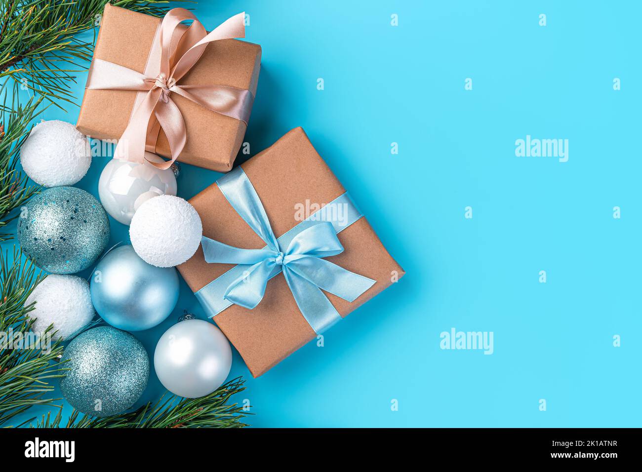 Christmas background with gifts, ribbons, toys and pine branches on a ...