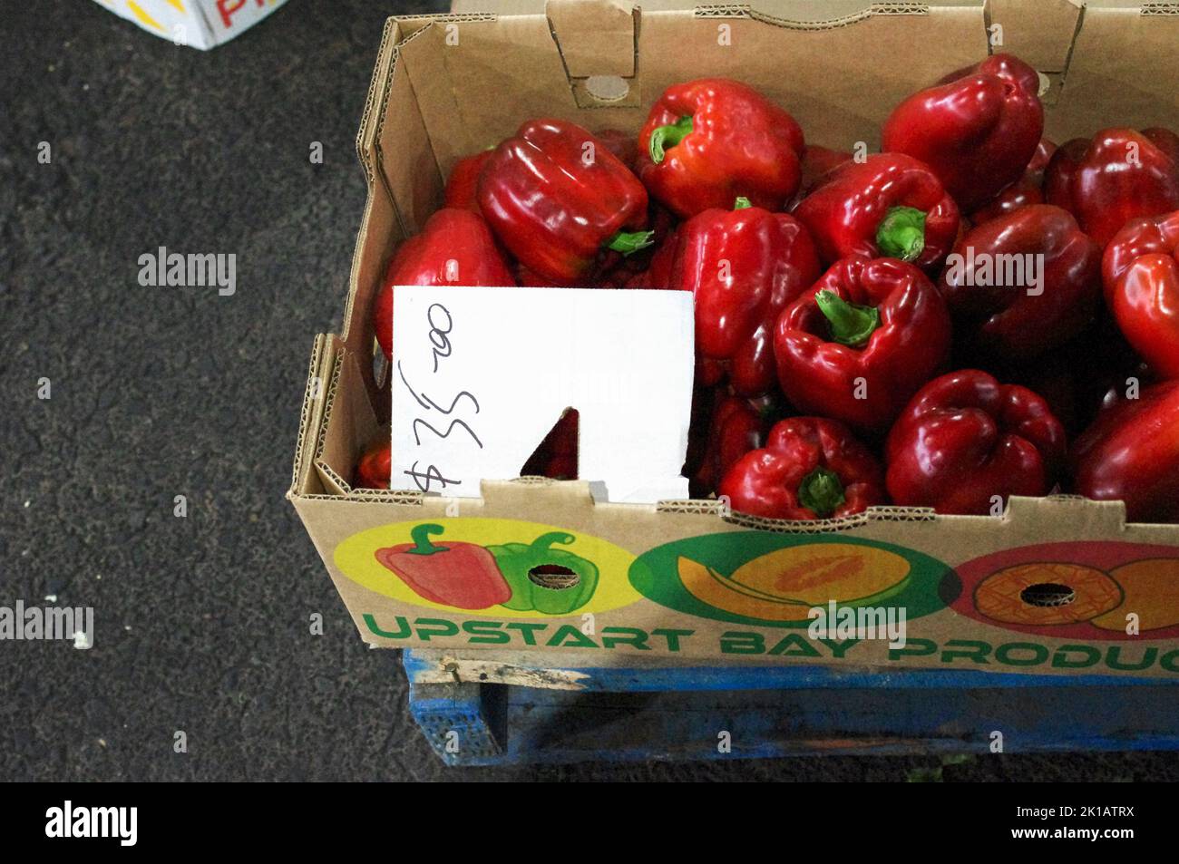 A box of red capsicums for sale at Paddy’s Fresh Food Market in ...