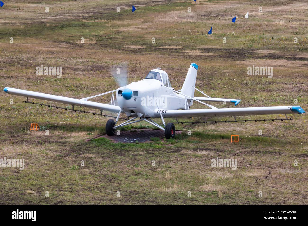 White aircraft for spraying agricultural fields at the airfield with a ...