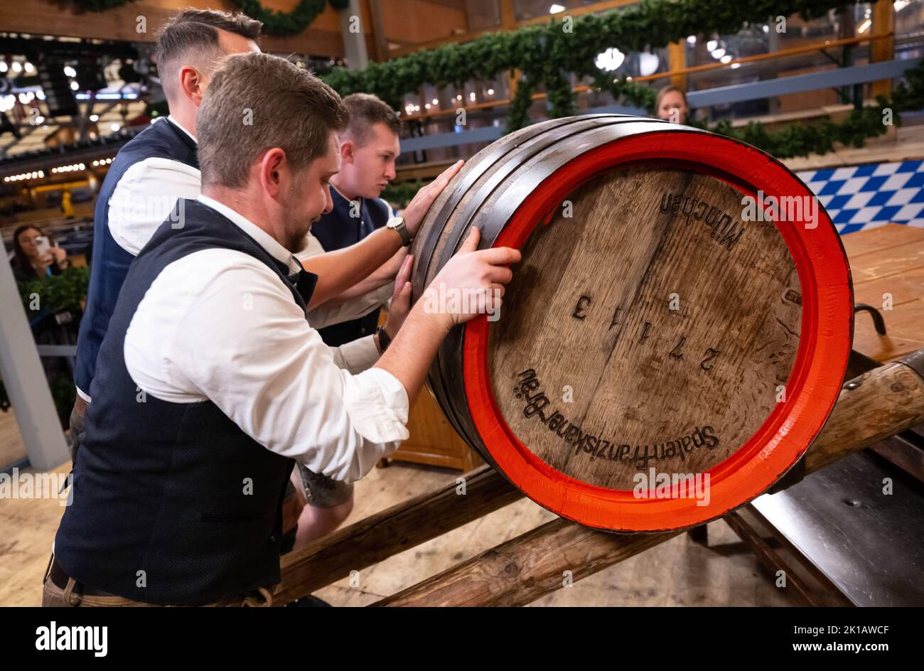Munich, Germany. 17th Sep, 2022. Employees roll the beer keg into a ...