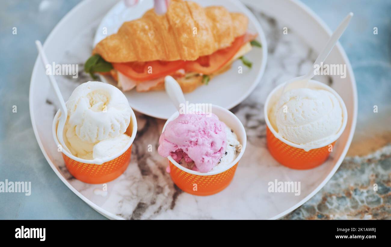 Ice cream and croissant with meat on the plate at the cafe Stock Photo ...