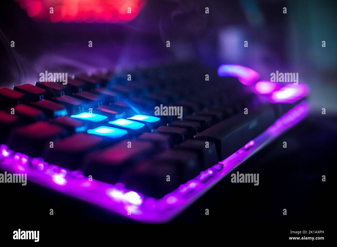 An illuminated computer keyboard with neon lights Stock Photo - Alamy