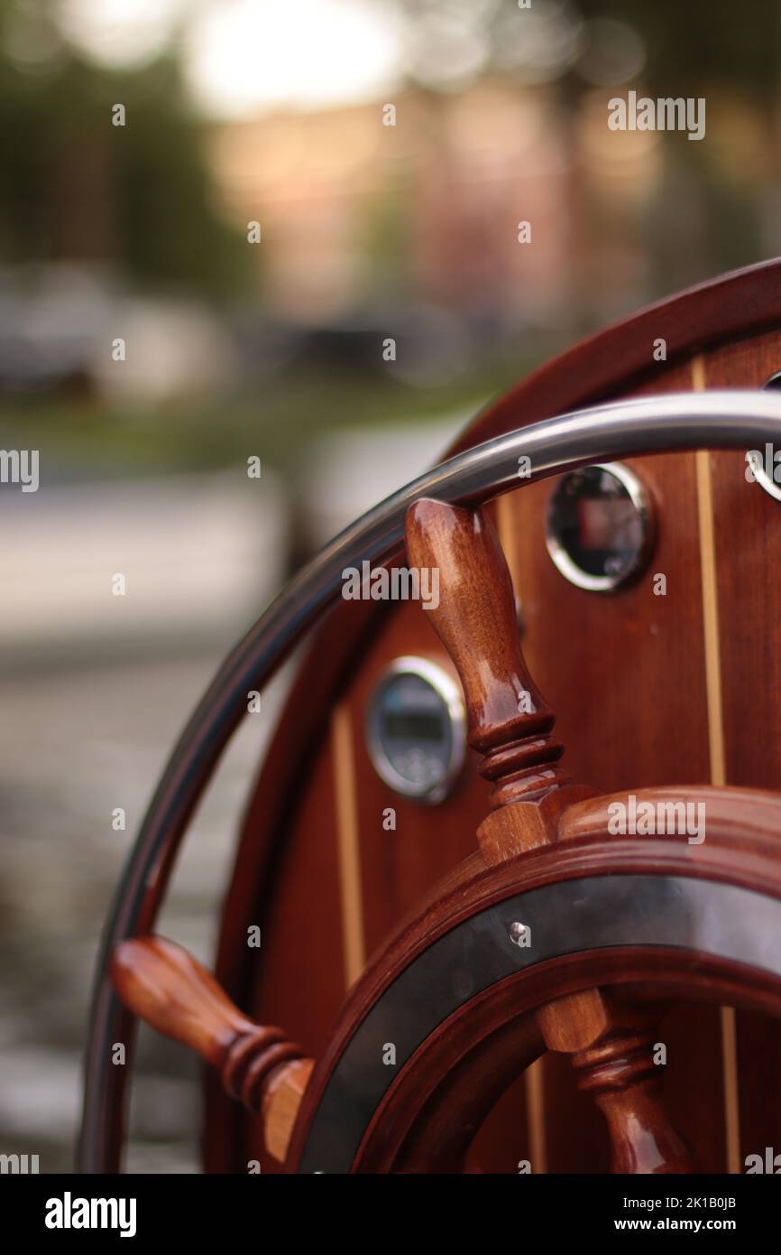 A vertical closeup of a vintage wooden boat wheel Stock Photo - Alamy