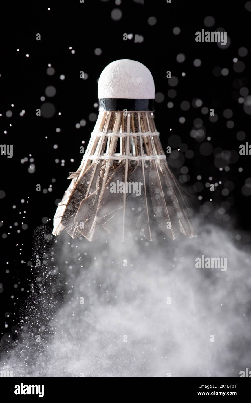 Feather shuttlecock in action, badminton game background Stock Photo ...