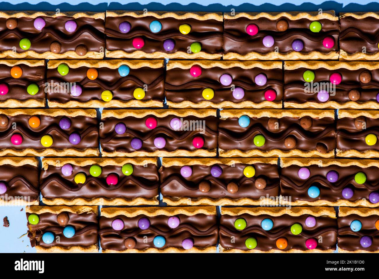 Chocolate biscuits with colorful chips, creative sweet food background ...