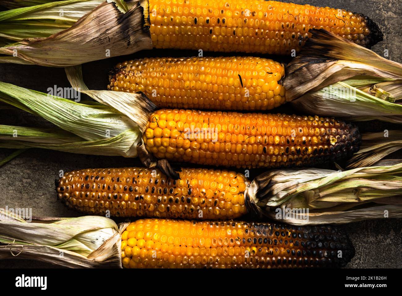 Roasted corn cobs on stone table, grilled organic food Stock Photo - Alamy