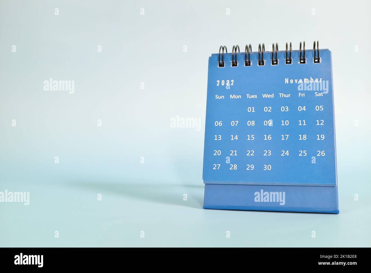 Selective focus of November 2022 desk calendar on blue background with ...