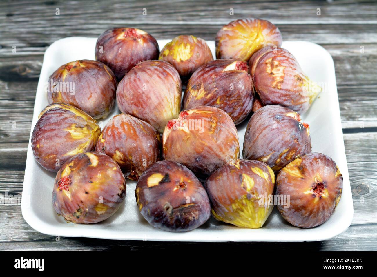 A plate of figs parchment fruit isolated on wooden background, fig is ...