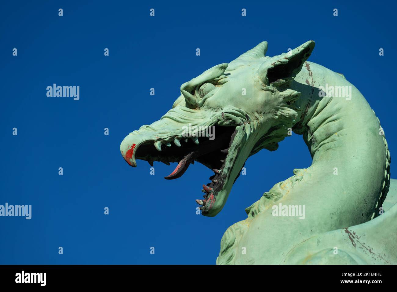 The Dragon statue head with open bloody mouth on the Dragon Bridge in ...