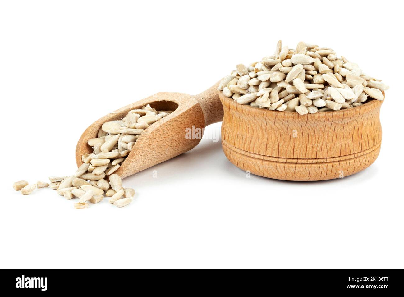 Hulled sunflower seeds in wooden bowl isolated on white background ...