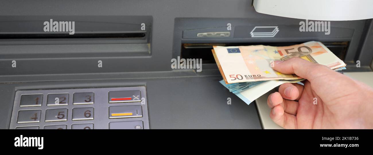 young person taking European money banknotes from an ATM machine Stock ...