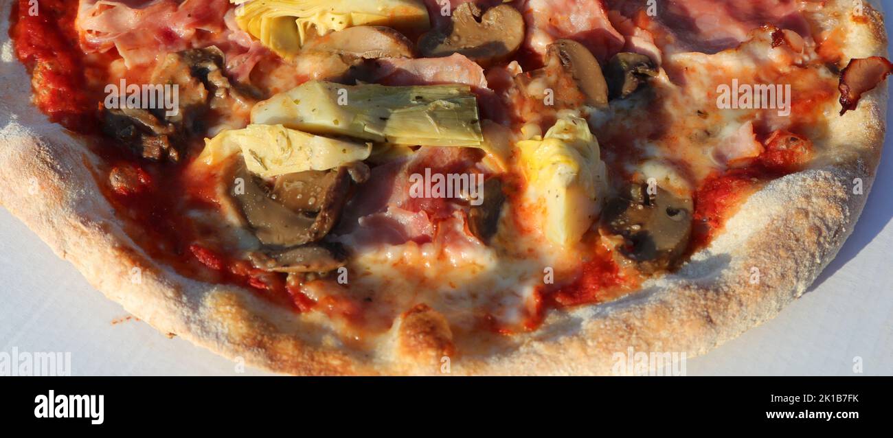 italian pizza with mushrooms ham artichokes cheese mozzarella and ...