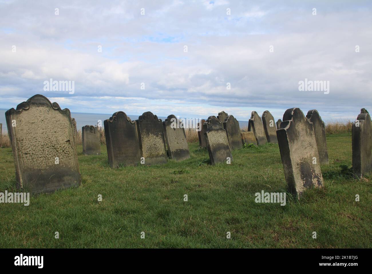 ancient gravestones in a church cemetery Stock Photo - Alamy