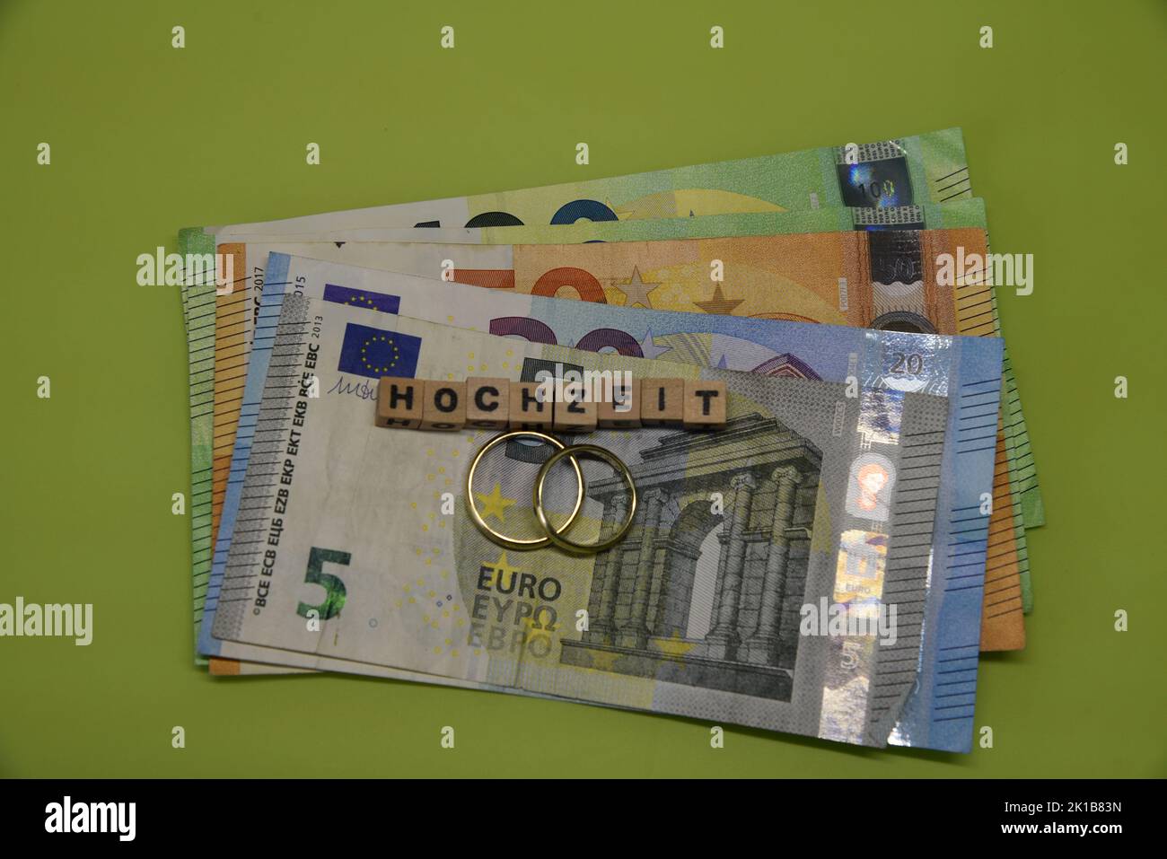 the german word for wedding with wodden bricks, two rings and euro bank ...