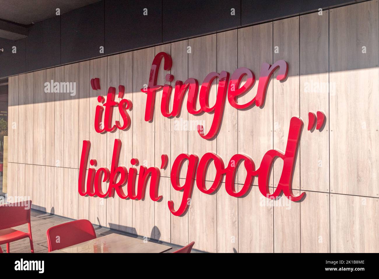 Pristina, Kosovo - June 5, 2022: It's finger lickin' good inscription. Promotion KFC slogan ...