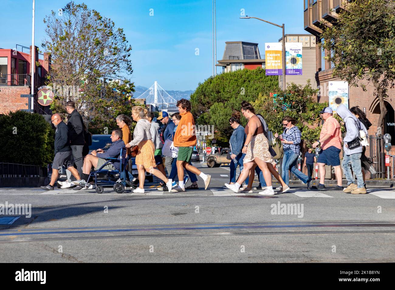 San Francisco, USA - June 7, 2022: people crossing a street at a ...