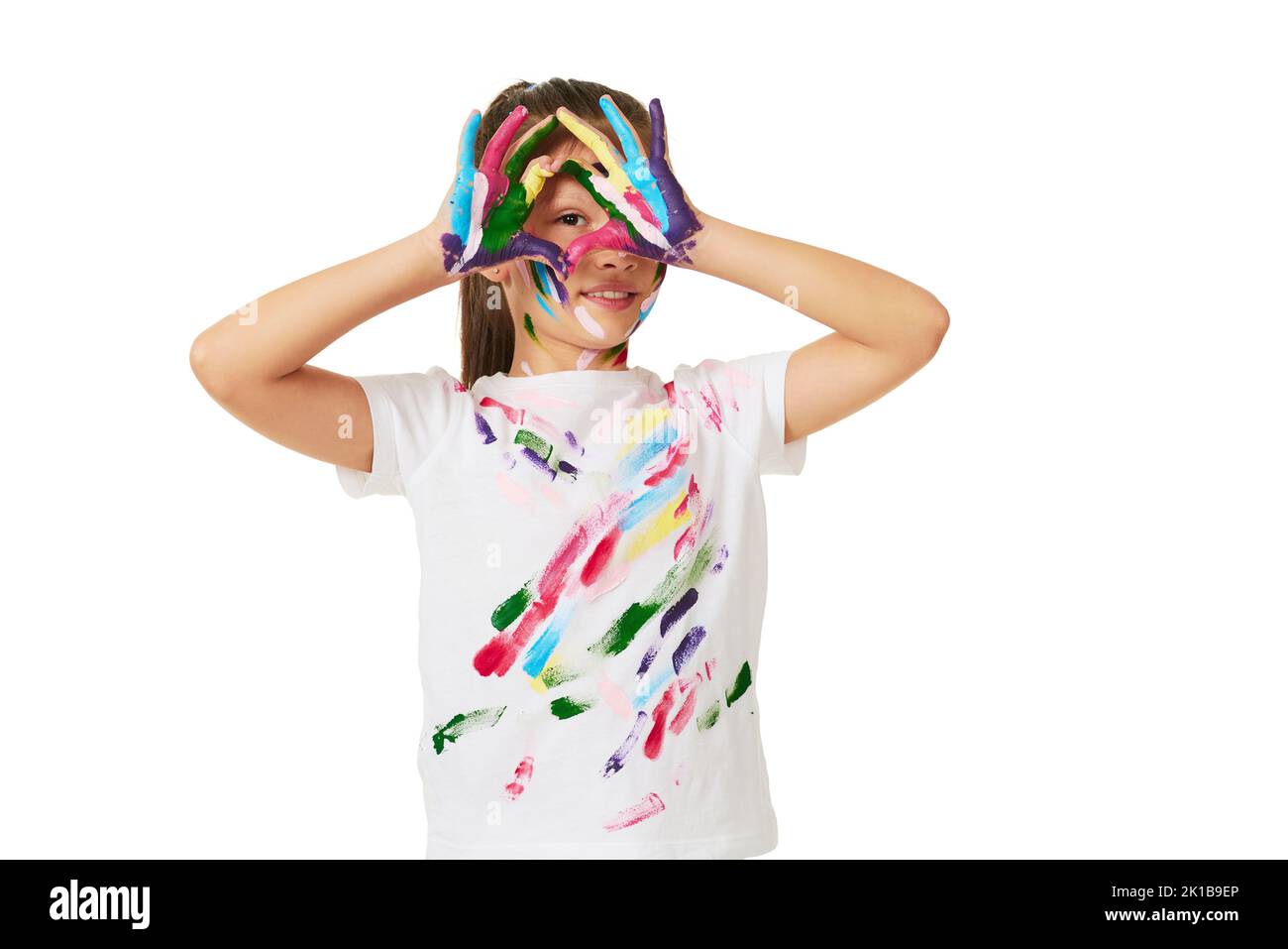 child girl with hands painted in colorful paint make heart shape Stock ...