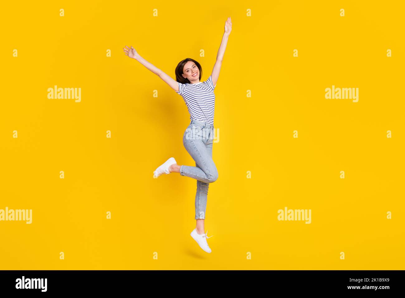 Full length photo of shiny young woman raise hands jumping high good ...