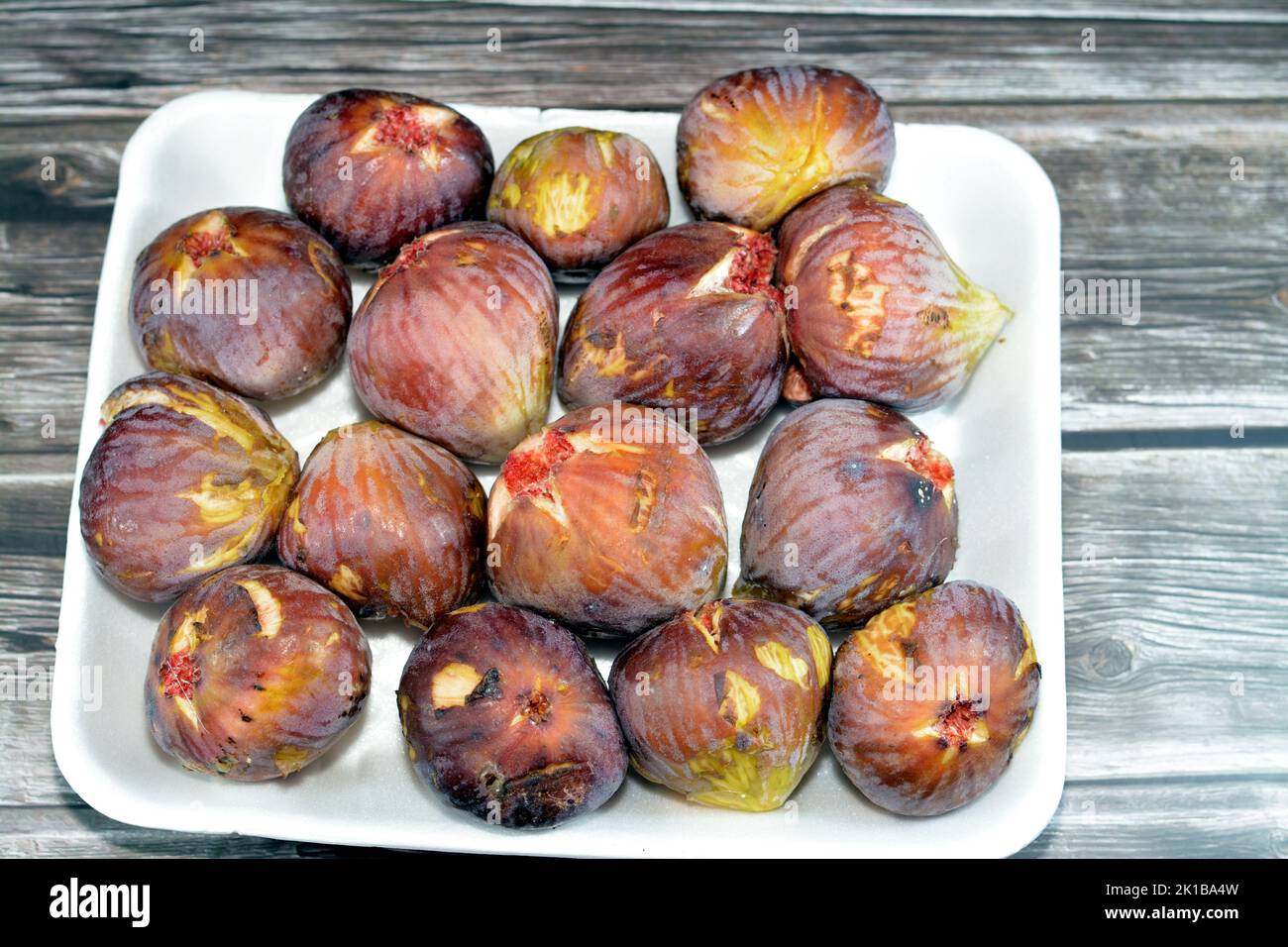 A plate of figs parchment fruit isolated on wooden background, fig is ...