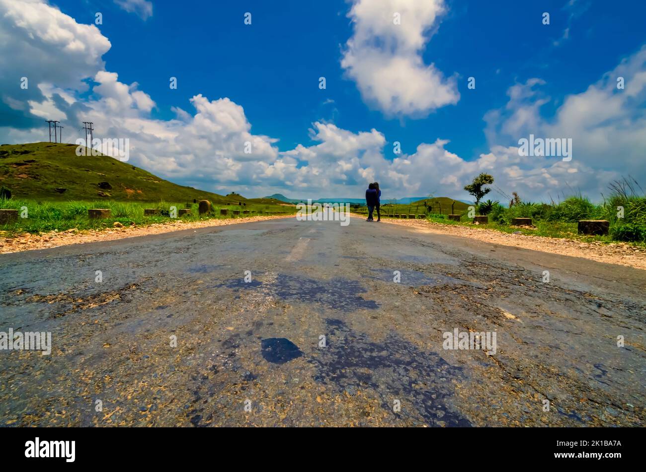 A worm's eye view of two travelers / travellers standing on the side of ...