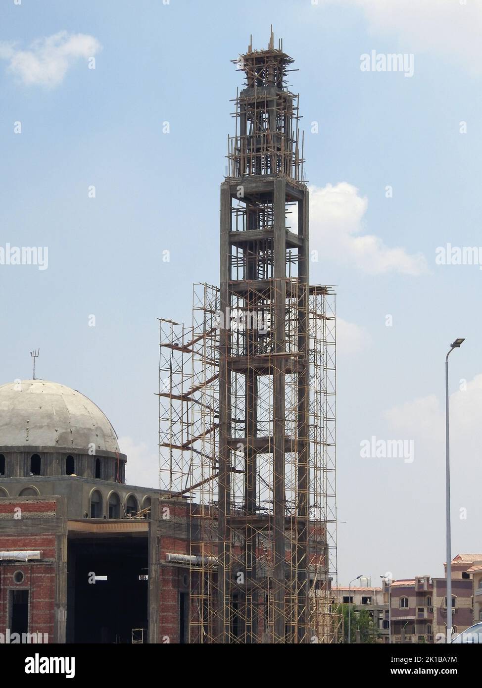 A new mosque under construction against the sunny blue sky with the ...