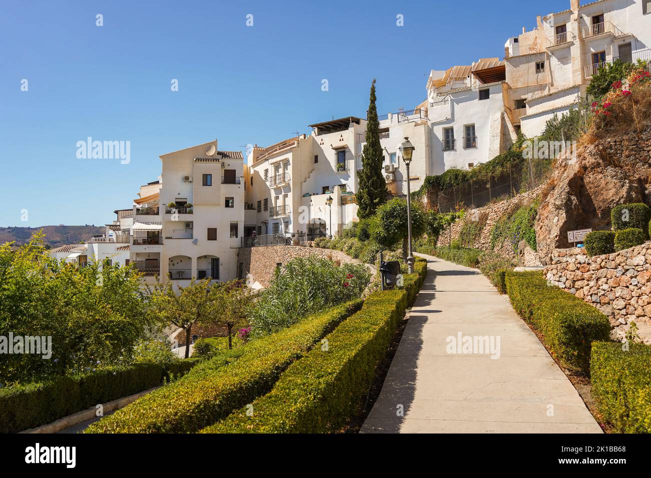Frigiliana Spain. Hillside gardens of white washed village of ...