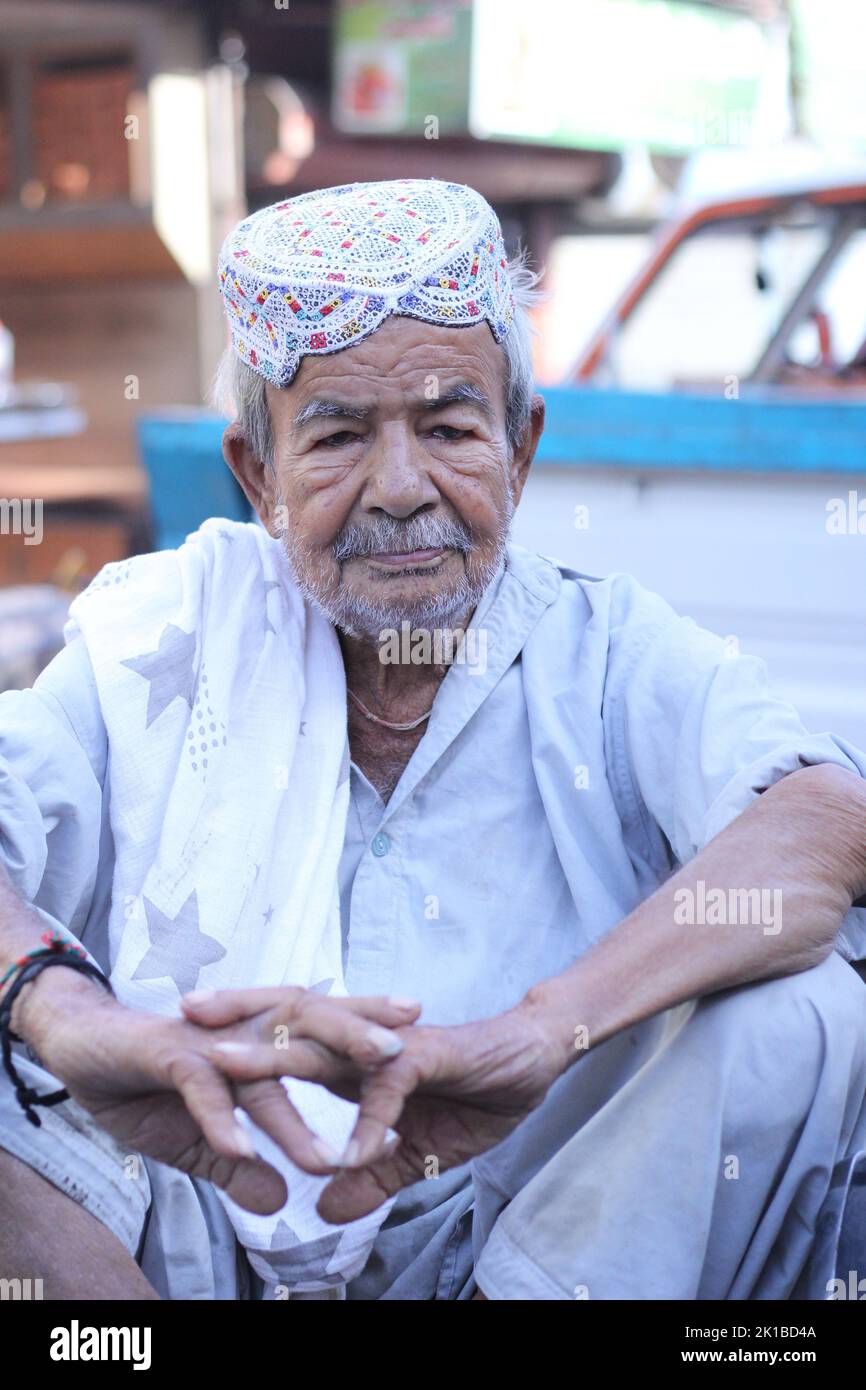 A vertical shallow focus of a Pakistani old male with a mustache in a ...